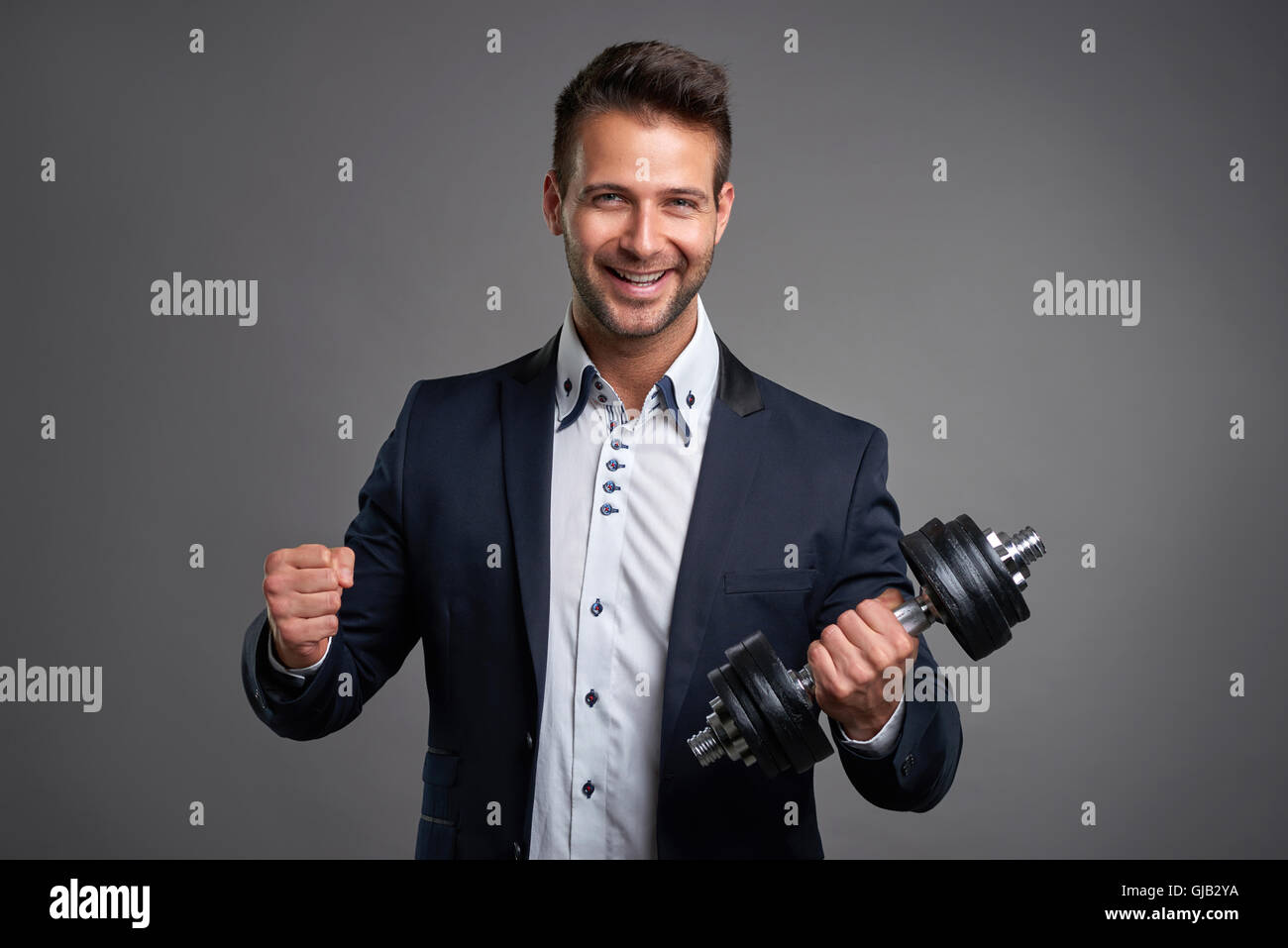 Elegant handsome young man feeling successful and holding a weight ...