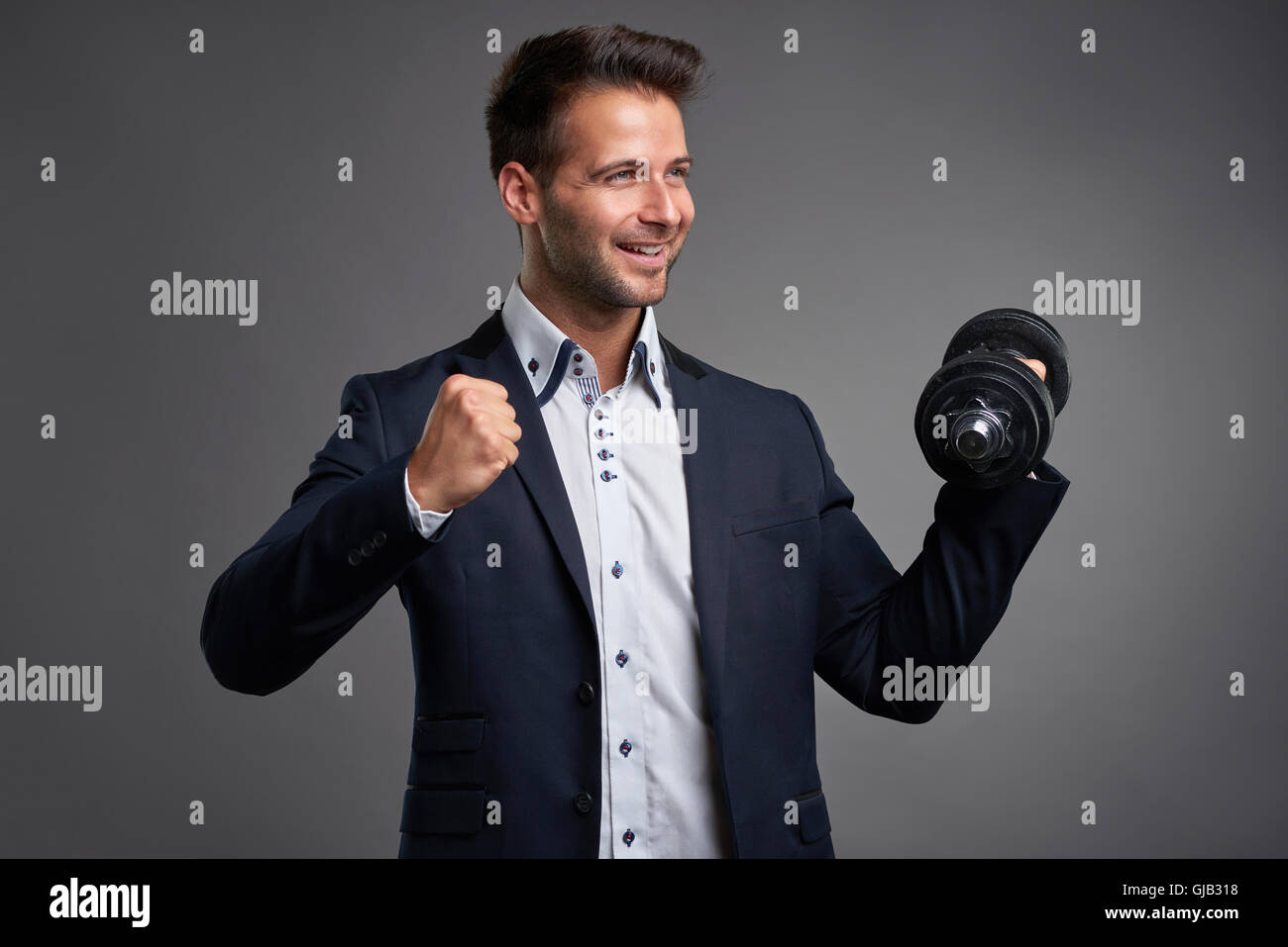 Elegant handsome young man feeling successful and holding a weight ...