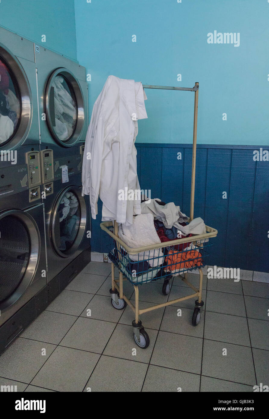 Washing clothes and drying at the Laundromat with chrome washer and ...