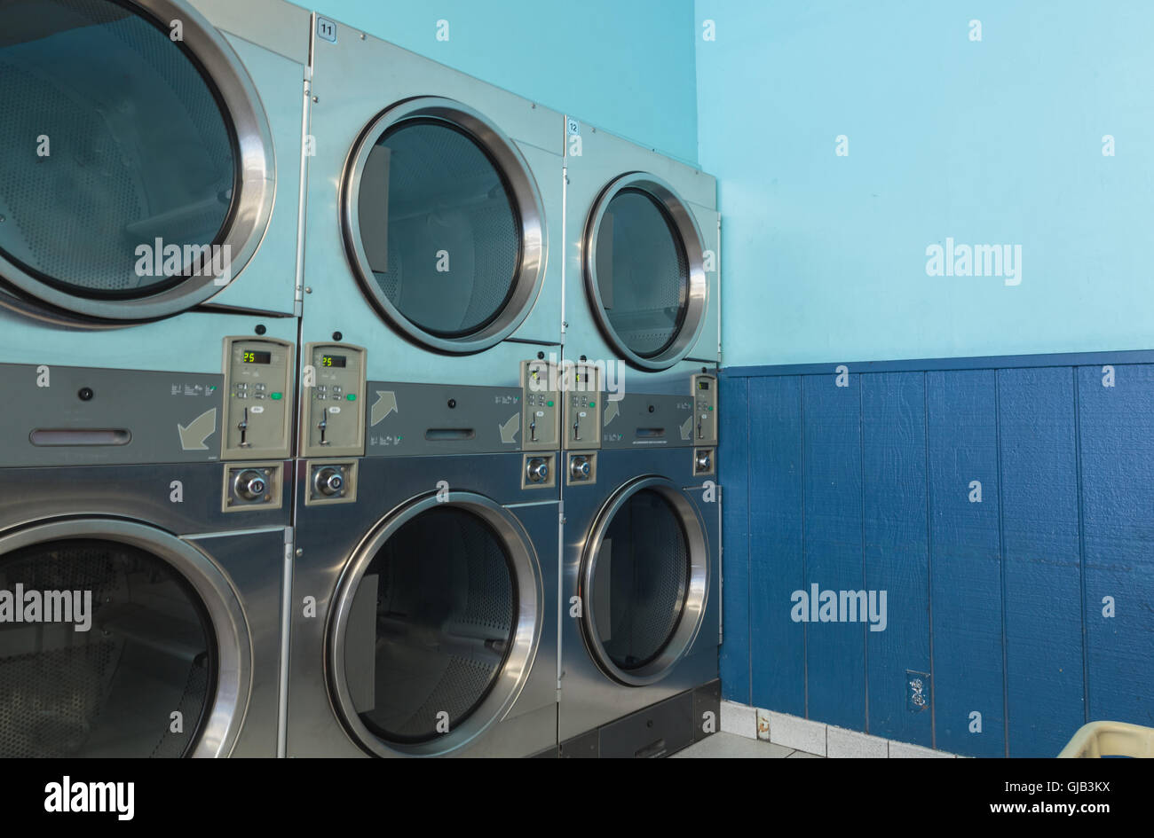 Washing clothes and drying at the Laundromat with chrome washer and ...