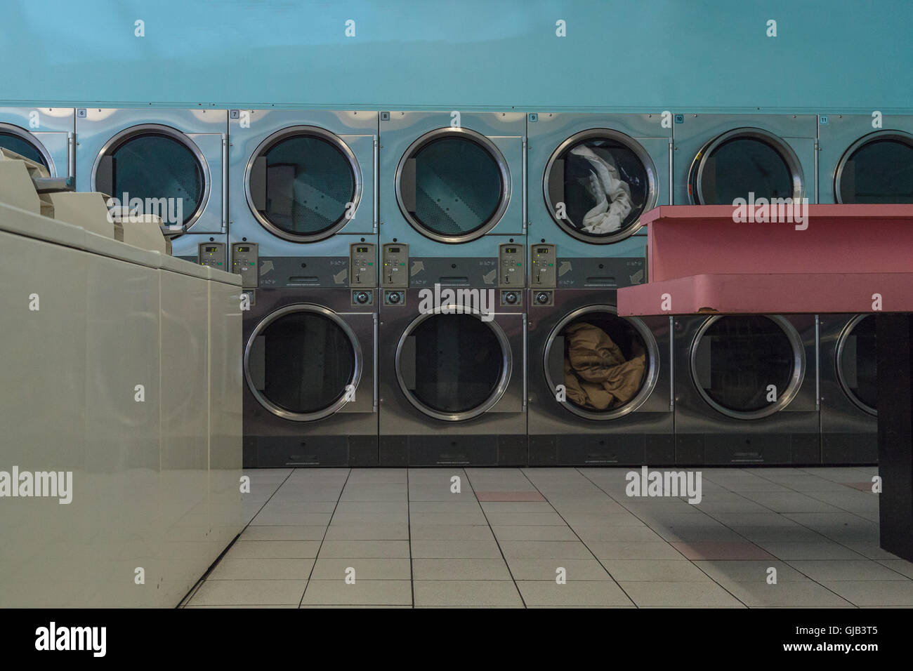 Washing clothes and drying at the Laundromat with chrome washer and ...