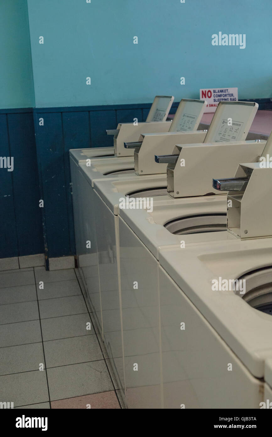 Washing clothes and drying at the Laundromat with chrome washer and ...