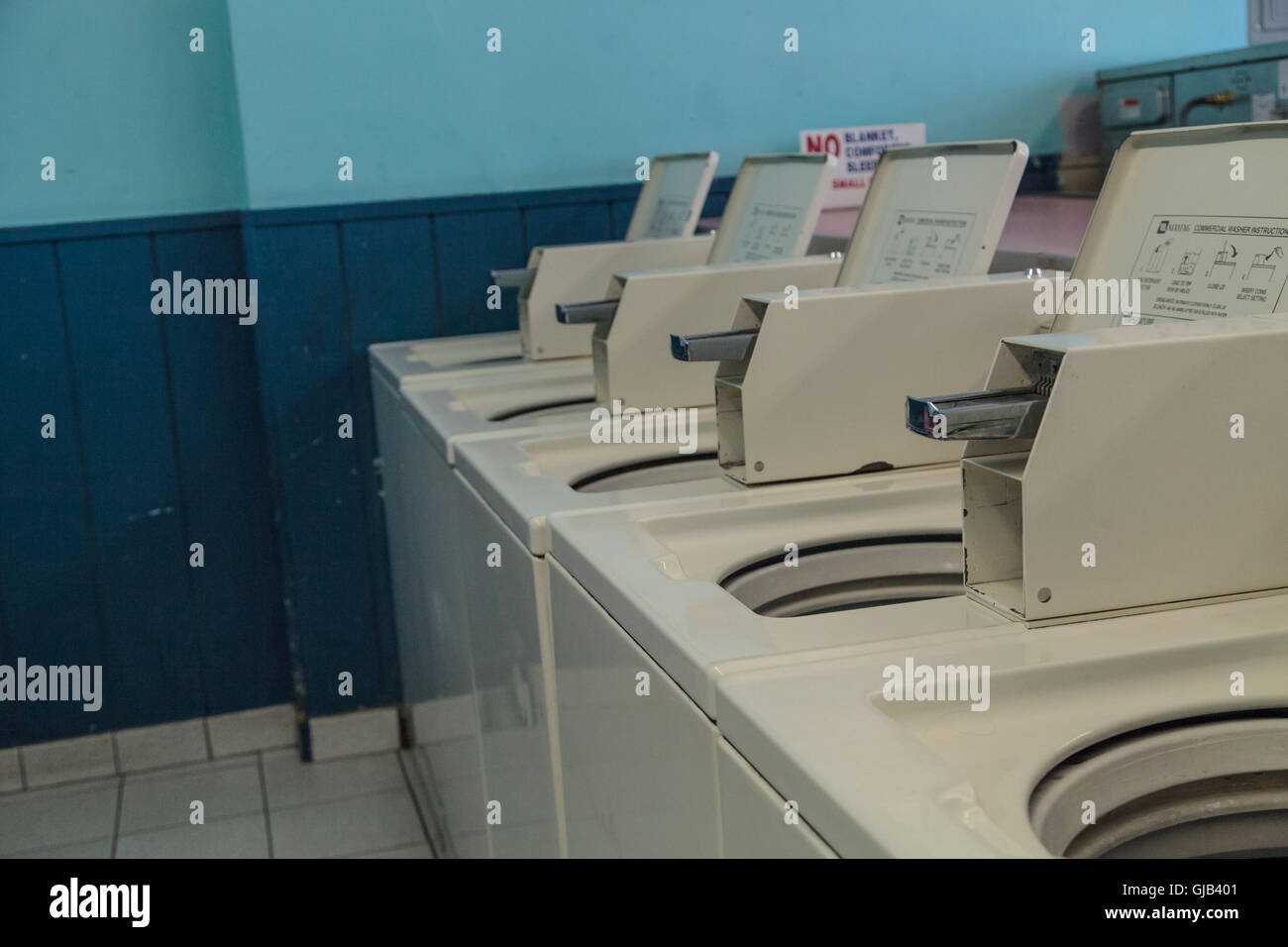 Washing clothes and drying at the Laundromat with chrome washer and ...