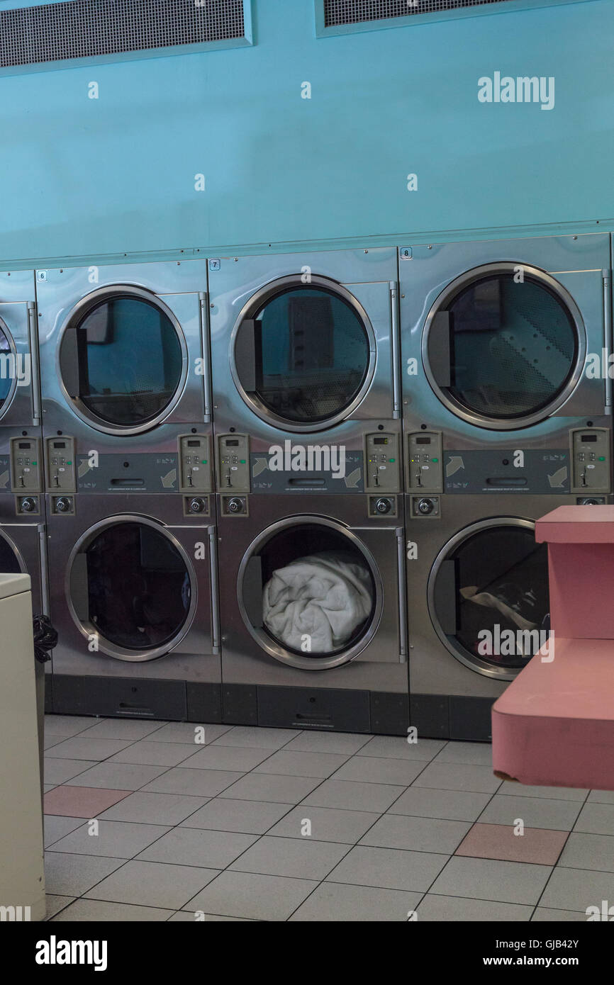 Washing clothes and drying at the Laundromat with chrome washer and ...