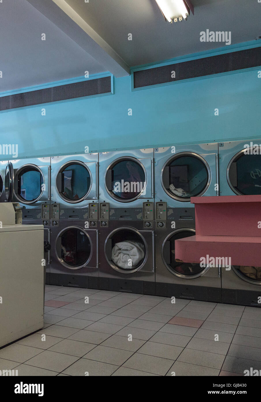 Washing clothes and drying at the Laundromat with chrome washer and ...