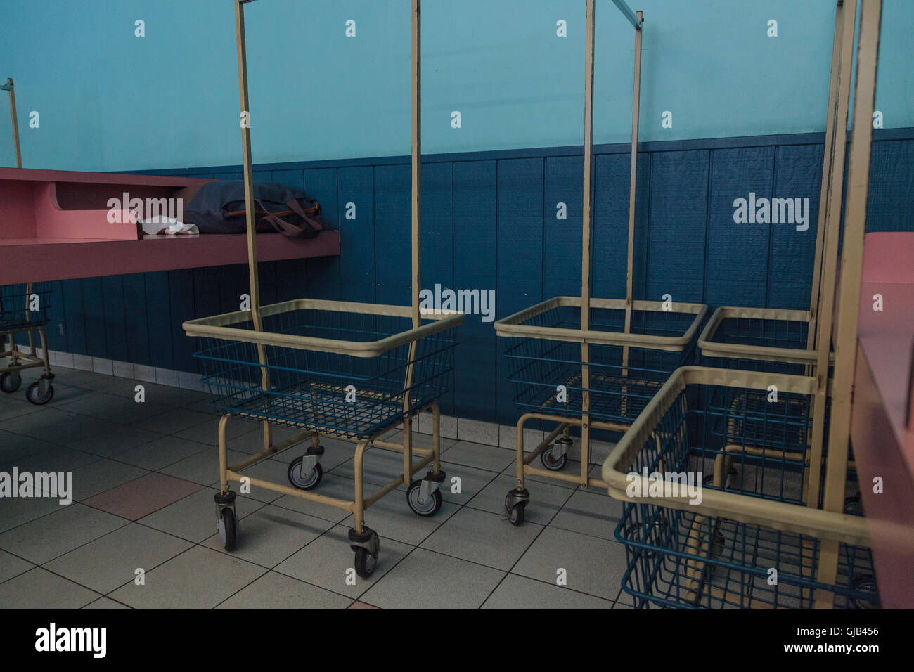 Empty laundry basket carts at a Laundromat Stock Photo - Alamy