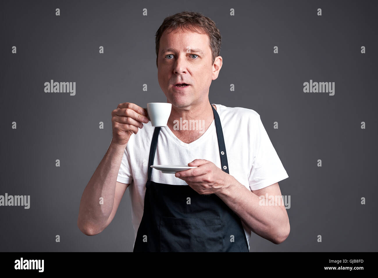 A middle age man drink and taste a cup of coffee Stock Photo - Alamy