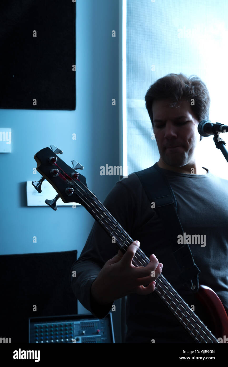 Black and white Portrait of a Rock singer playing bass in the rehearsal ...