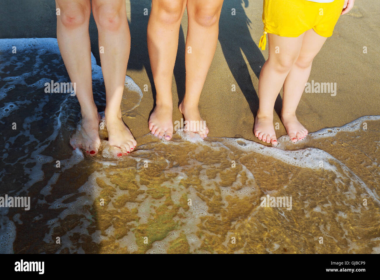 shapely female legs in the sand near the ocean Stock Photo - Alamy