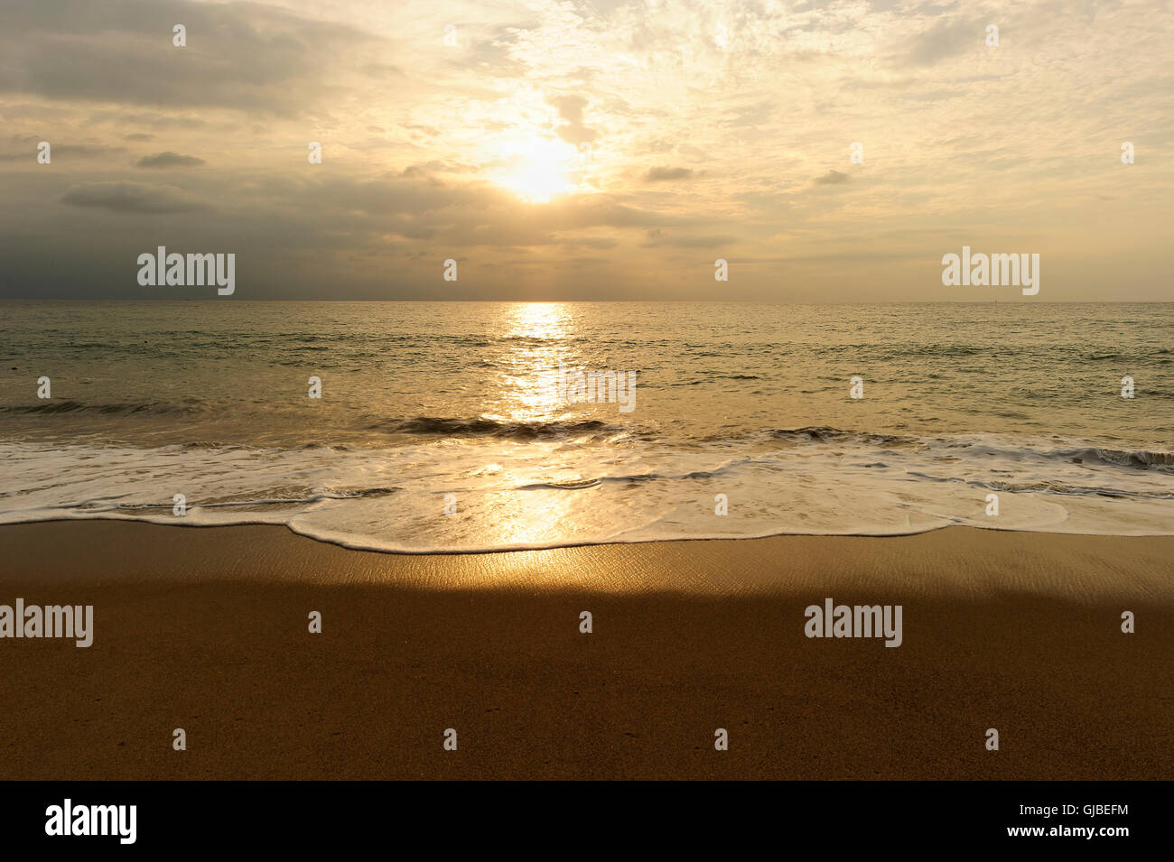 Golden ocean sunset is a beach scenic with a soft bright ethereal light ...