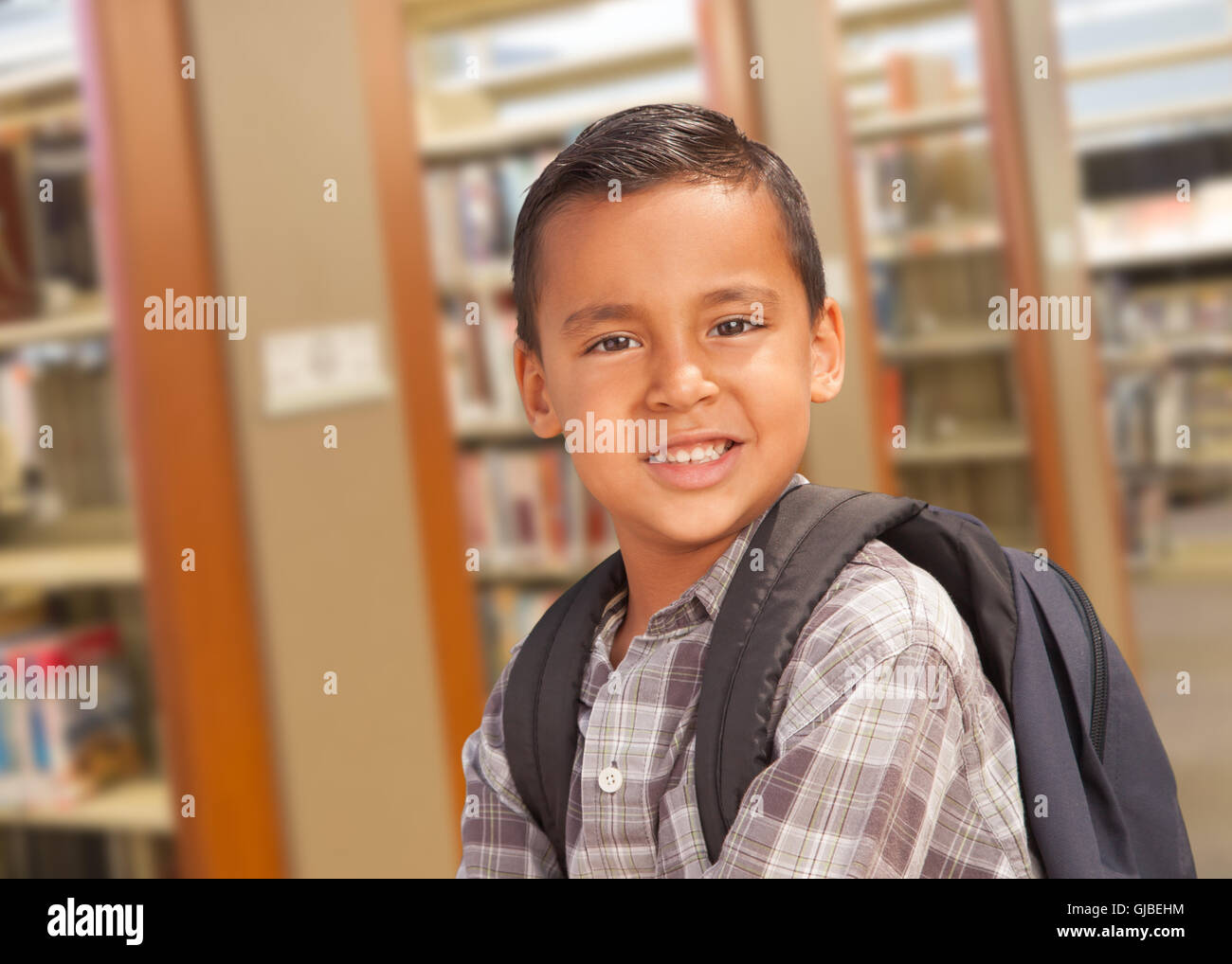 Happy Hispanic Student Boy with Backpack in the Library Stock Photo - Alamy