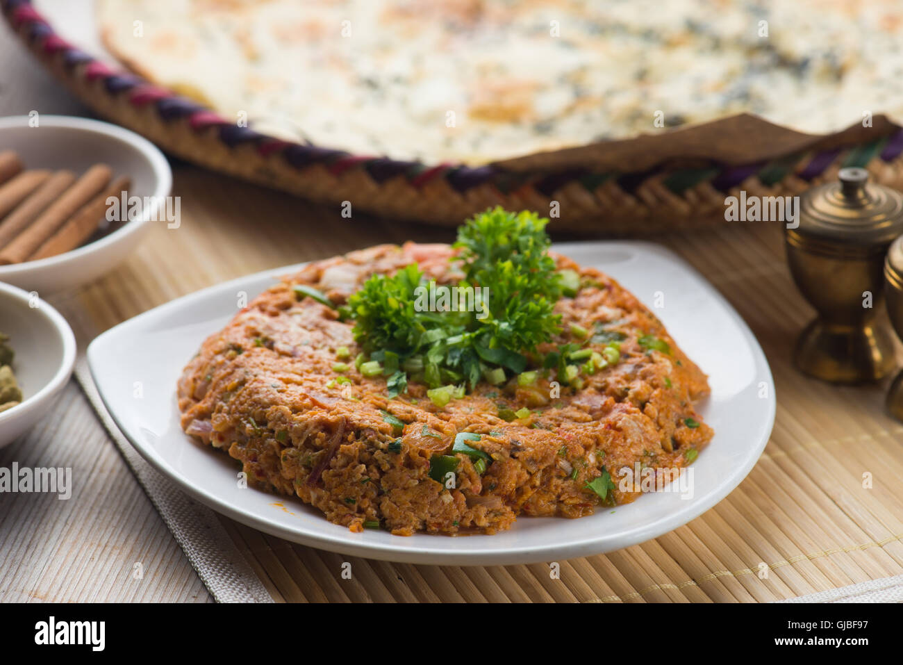 oqda , fried potatoes with meat popular arab food Stock Photo - Alamy