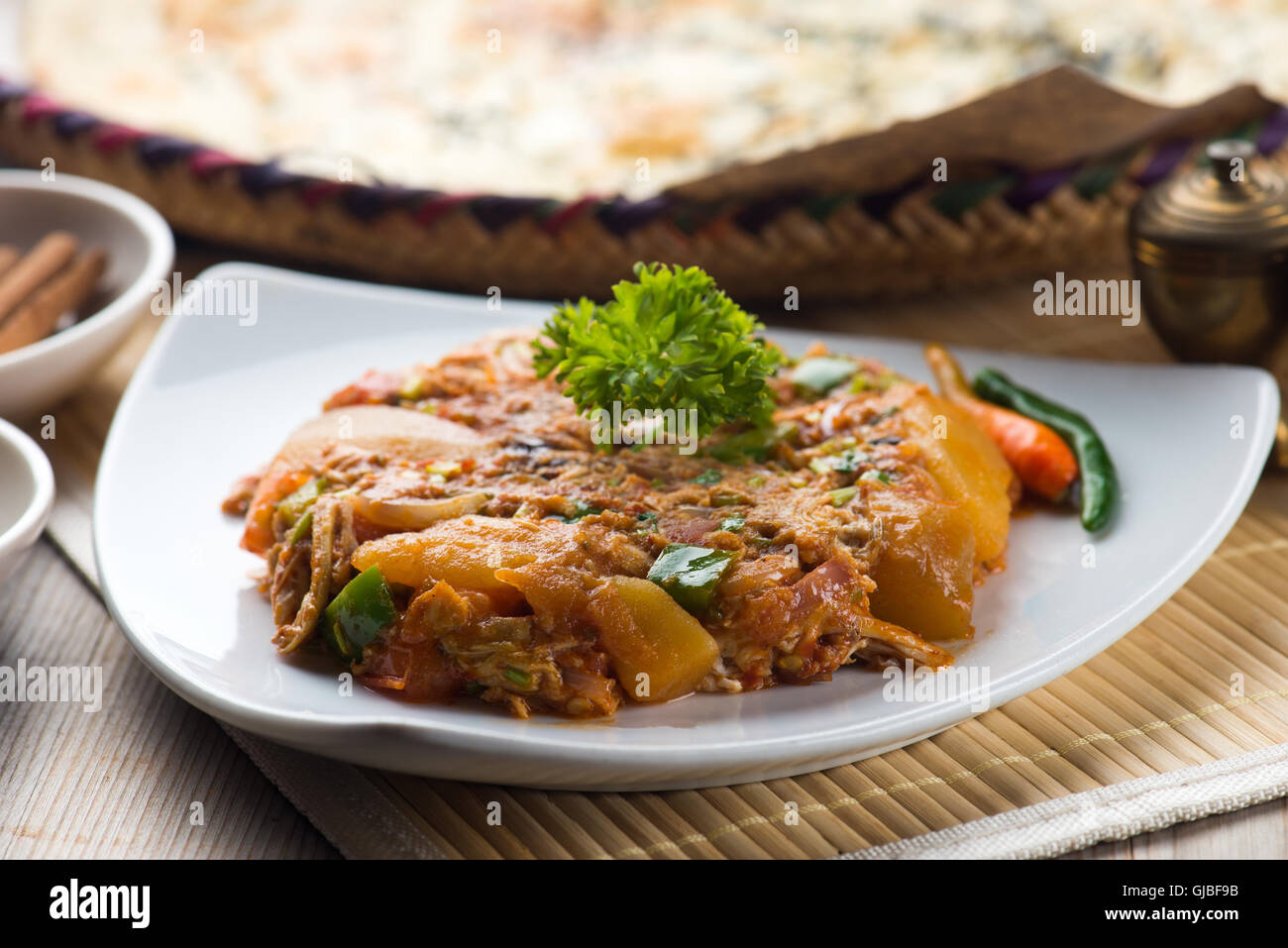 oqda popular arab food, fried potatoes with meat Stock Photo - Alamy