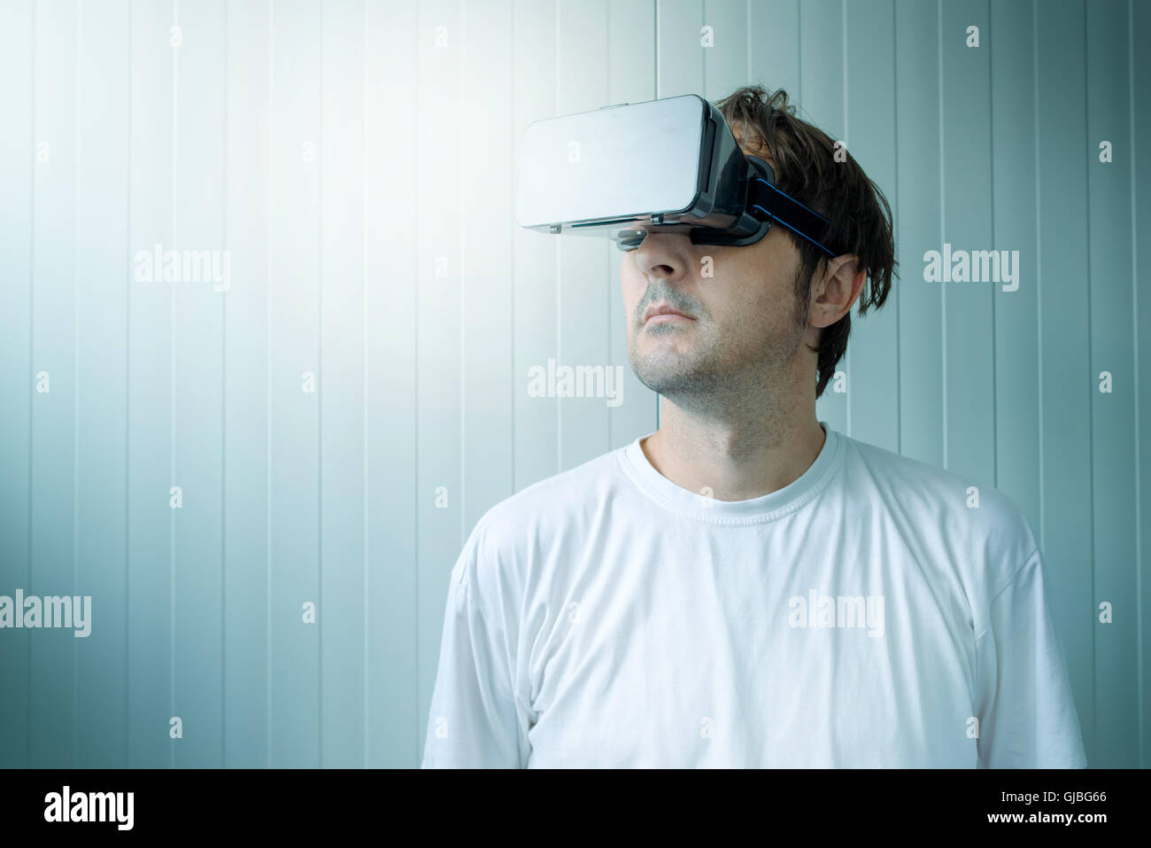 Man with VR headset goggles viewing realistic 3d virtual reality ...