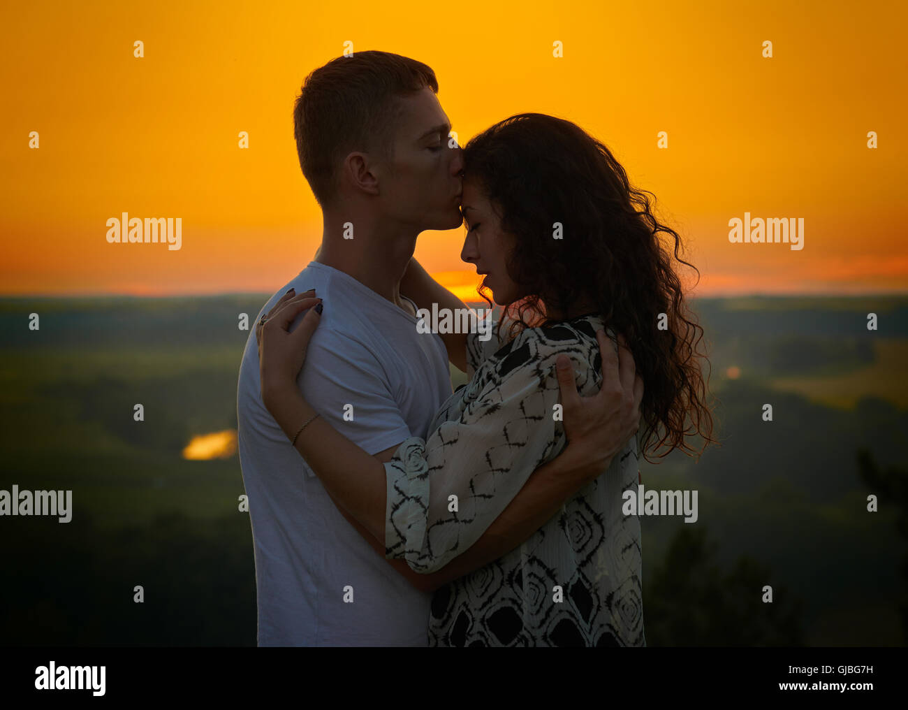 romantic couple at sunset on outdoor, beautiful landscape with bright ...