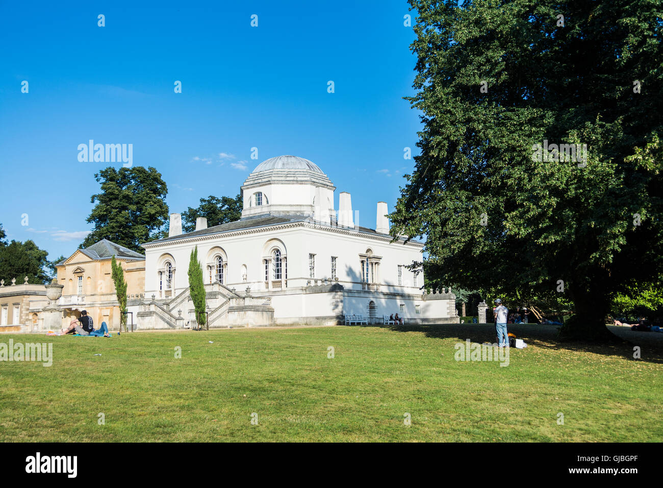 People relaxing in the grounds of Chiswick House, an early 18thC ...