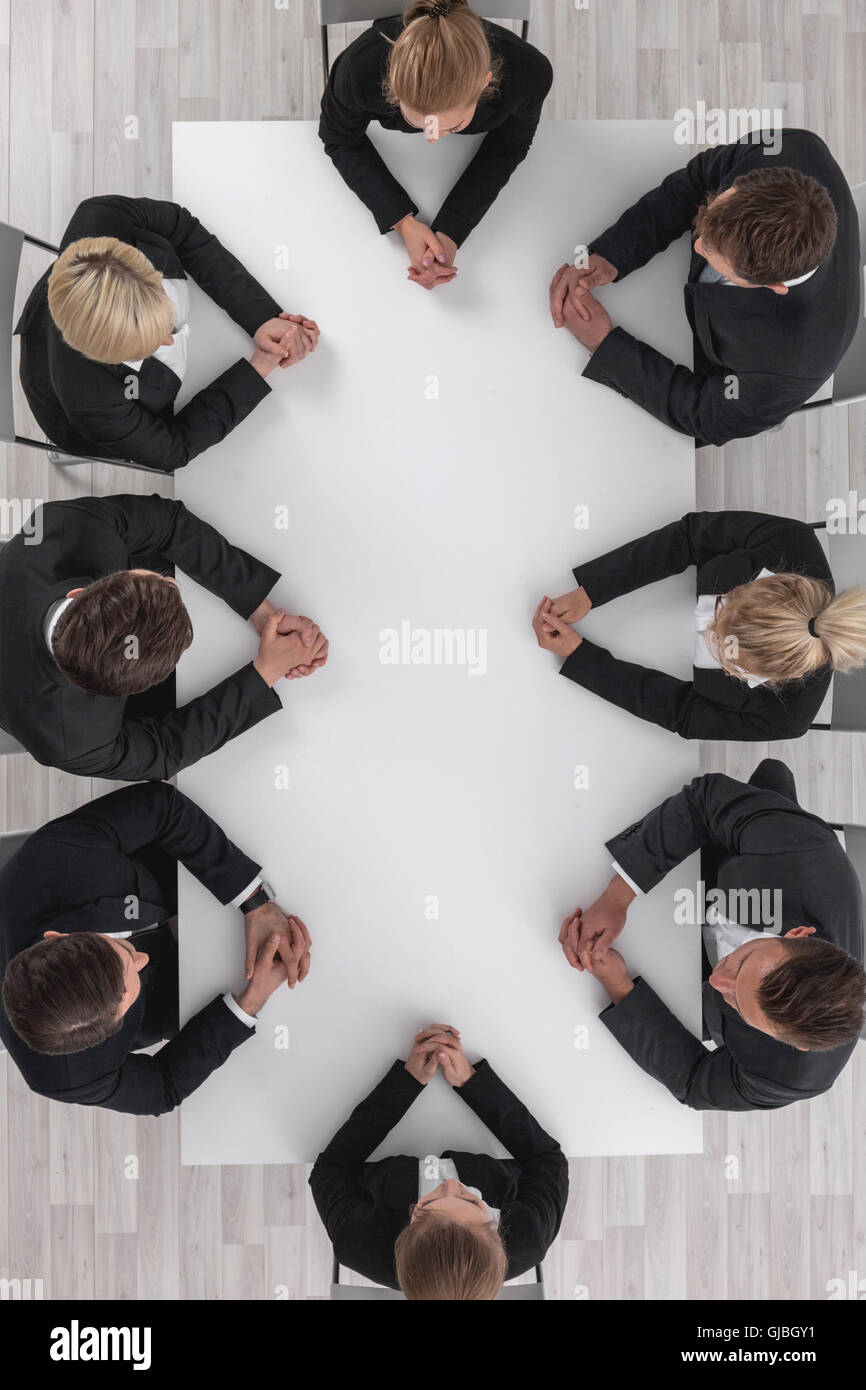 Diverse business people sitting around the table on a meeting Stock ...