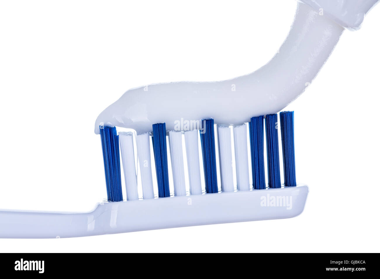 Toothbrush while putting on the toothpaste isolated on white Stock ...