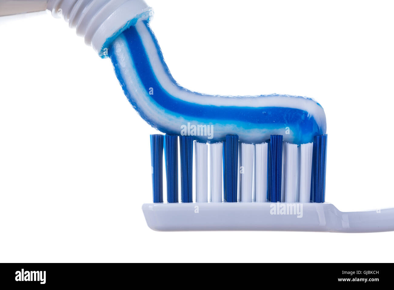 Toothbrush while putting on the toothpaste isolated on white Stock ...