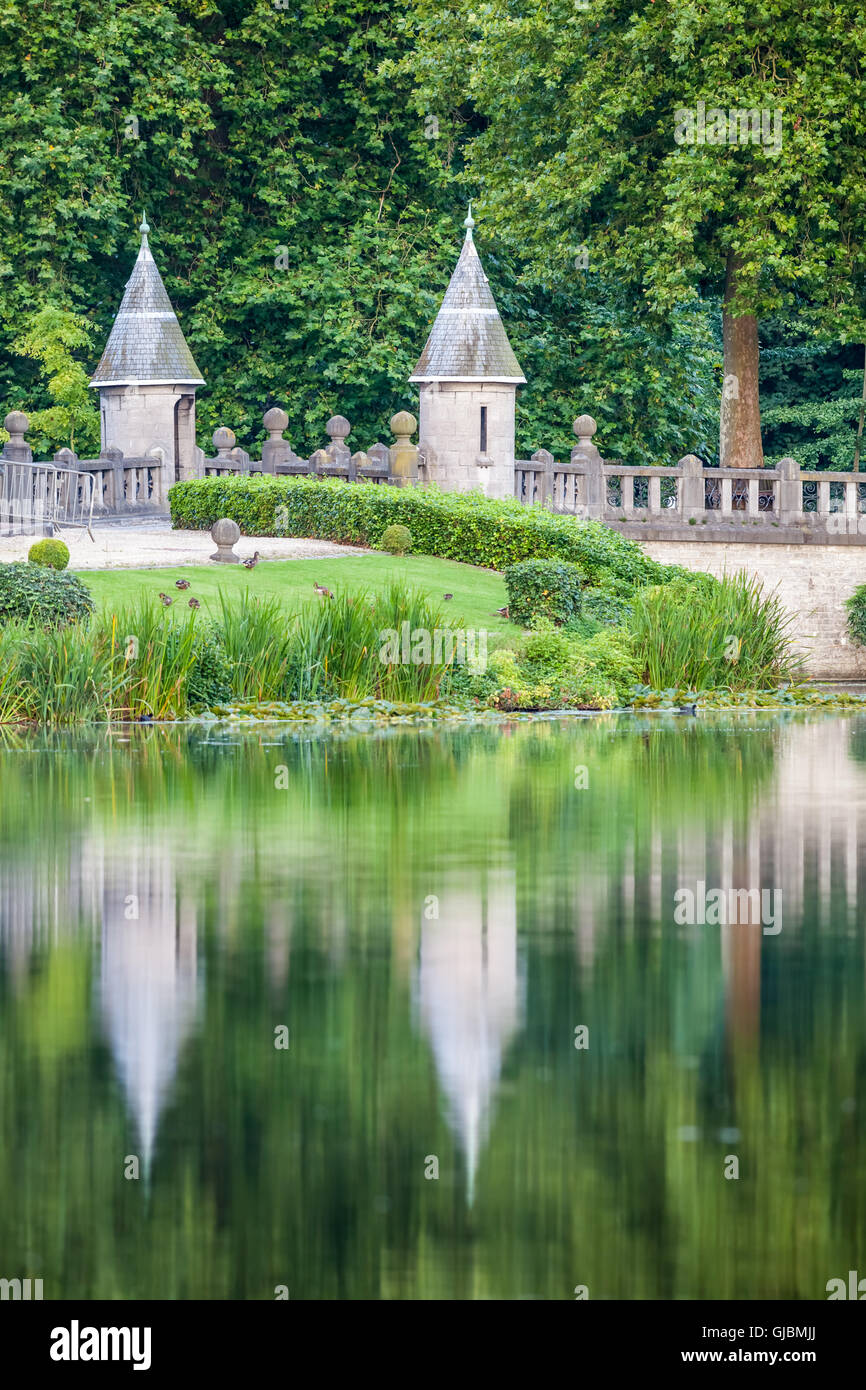 an reflection of two towers of a castle with nature on the water Stock ...