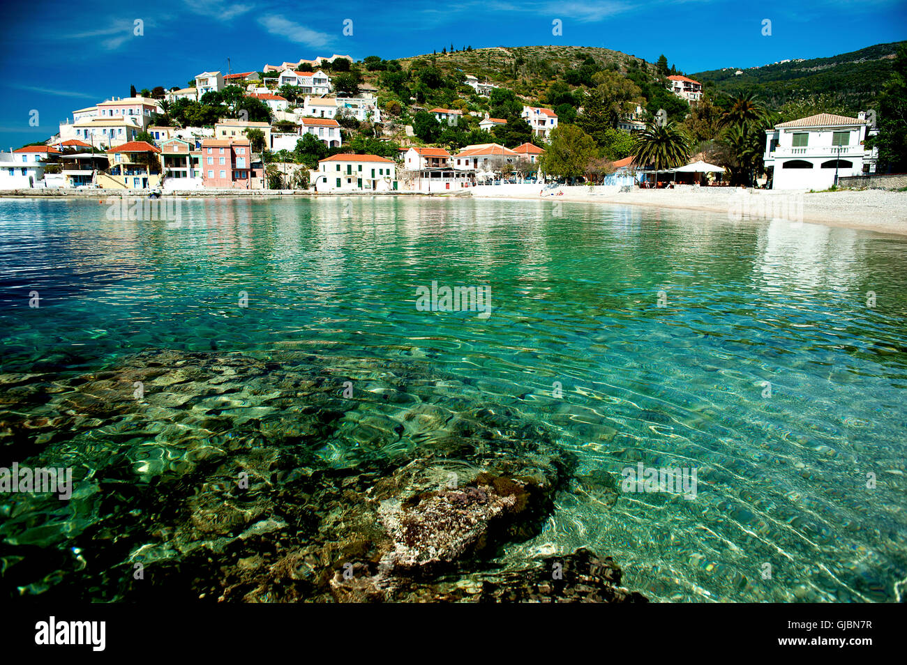 The idyllic beach and turquoise sea at Assos on the Greek island of ...