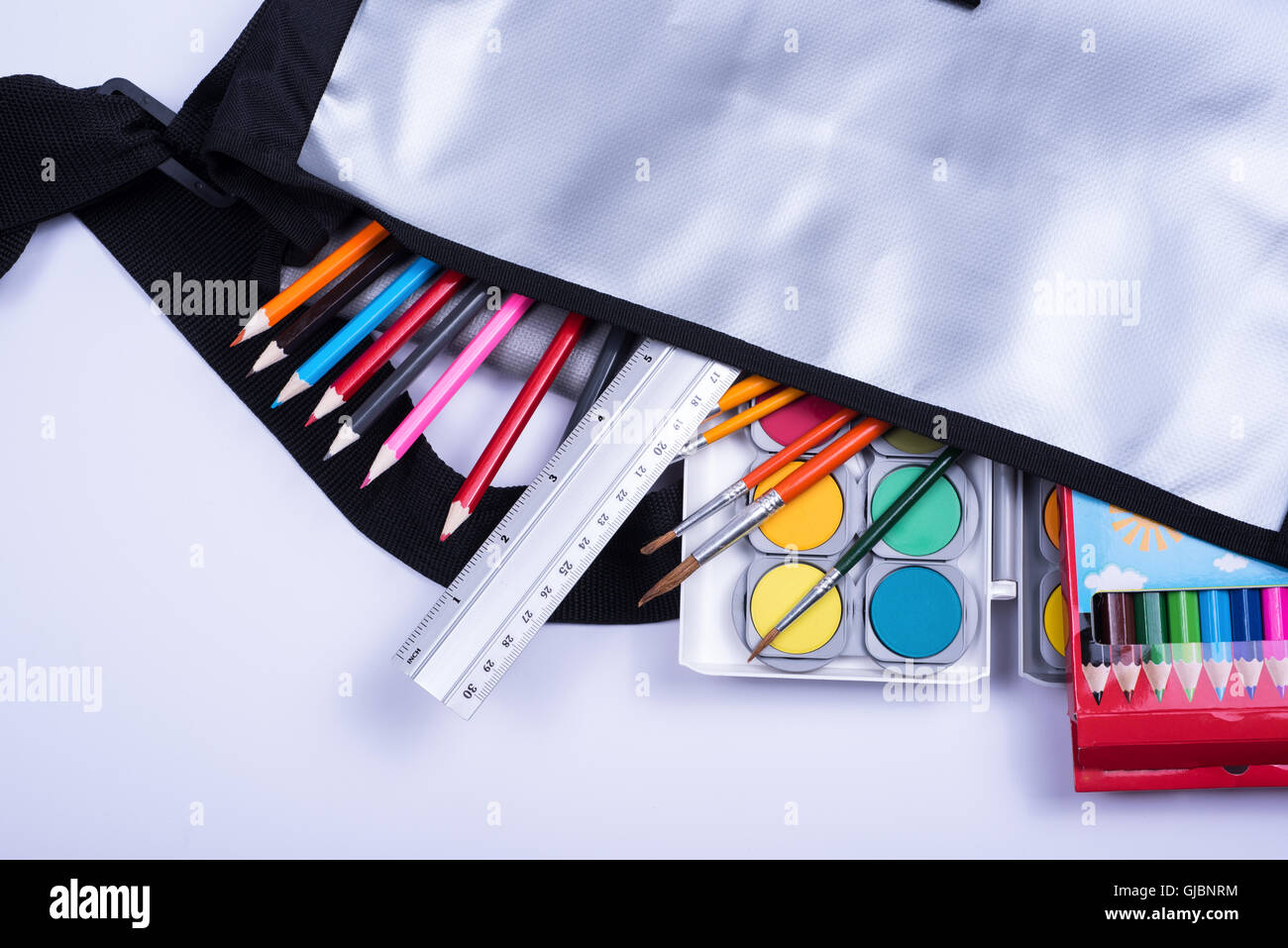 open bag with colorful items for the school start Stock Photo - Alamy