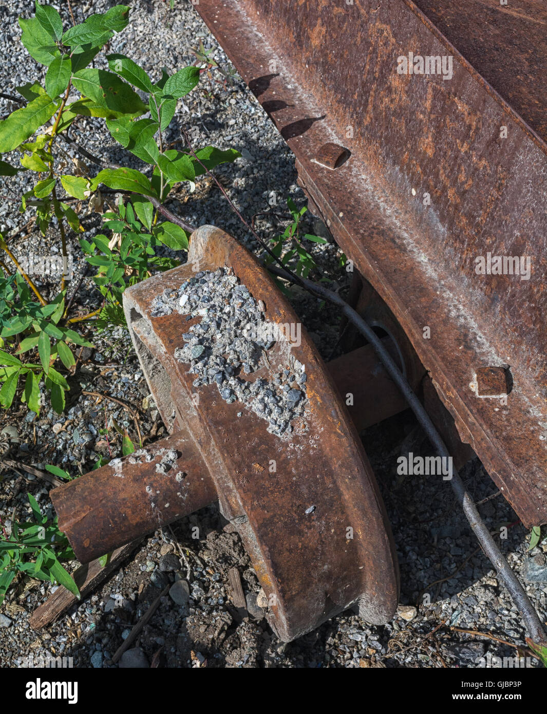 Gravel rests on the top of a rusting mine cart wheel Stock Photo - Alamy