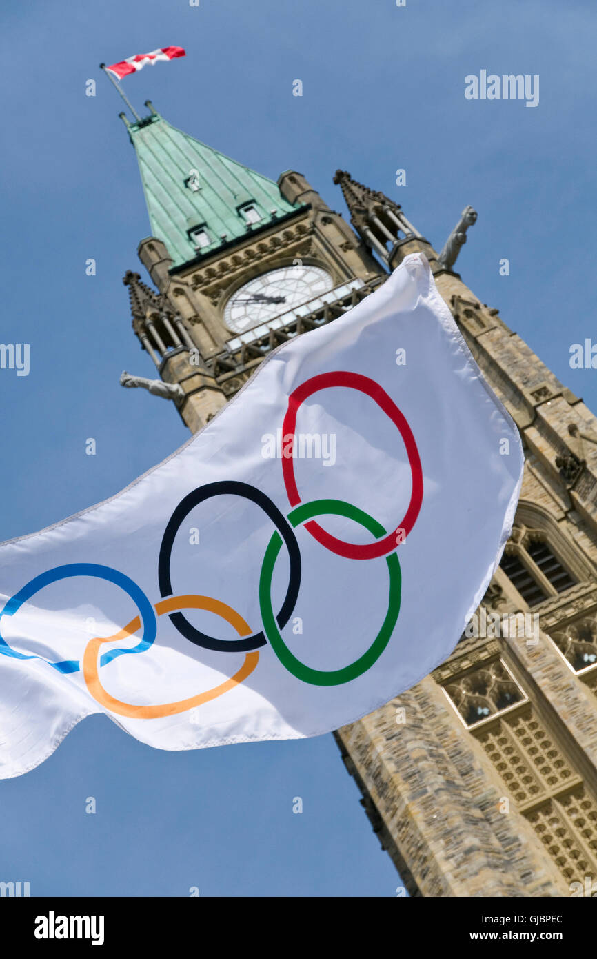 The Olympic flag flying in front of the Peace Tower at the Canadian ...