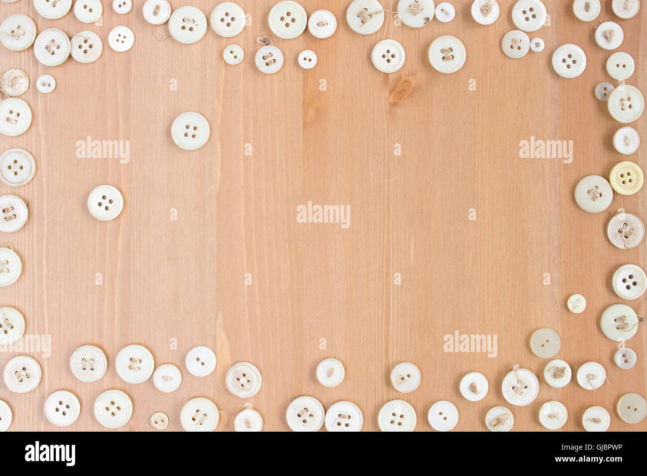 Border made of white vintage buttons on wooden background Stock Photo ...