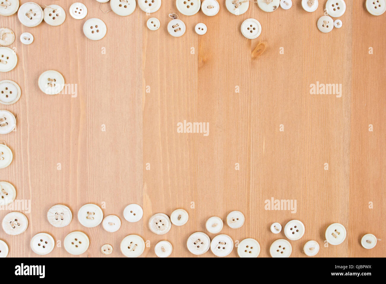 Frame border made of old buttons on wooden background Stock Photo - Alamy