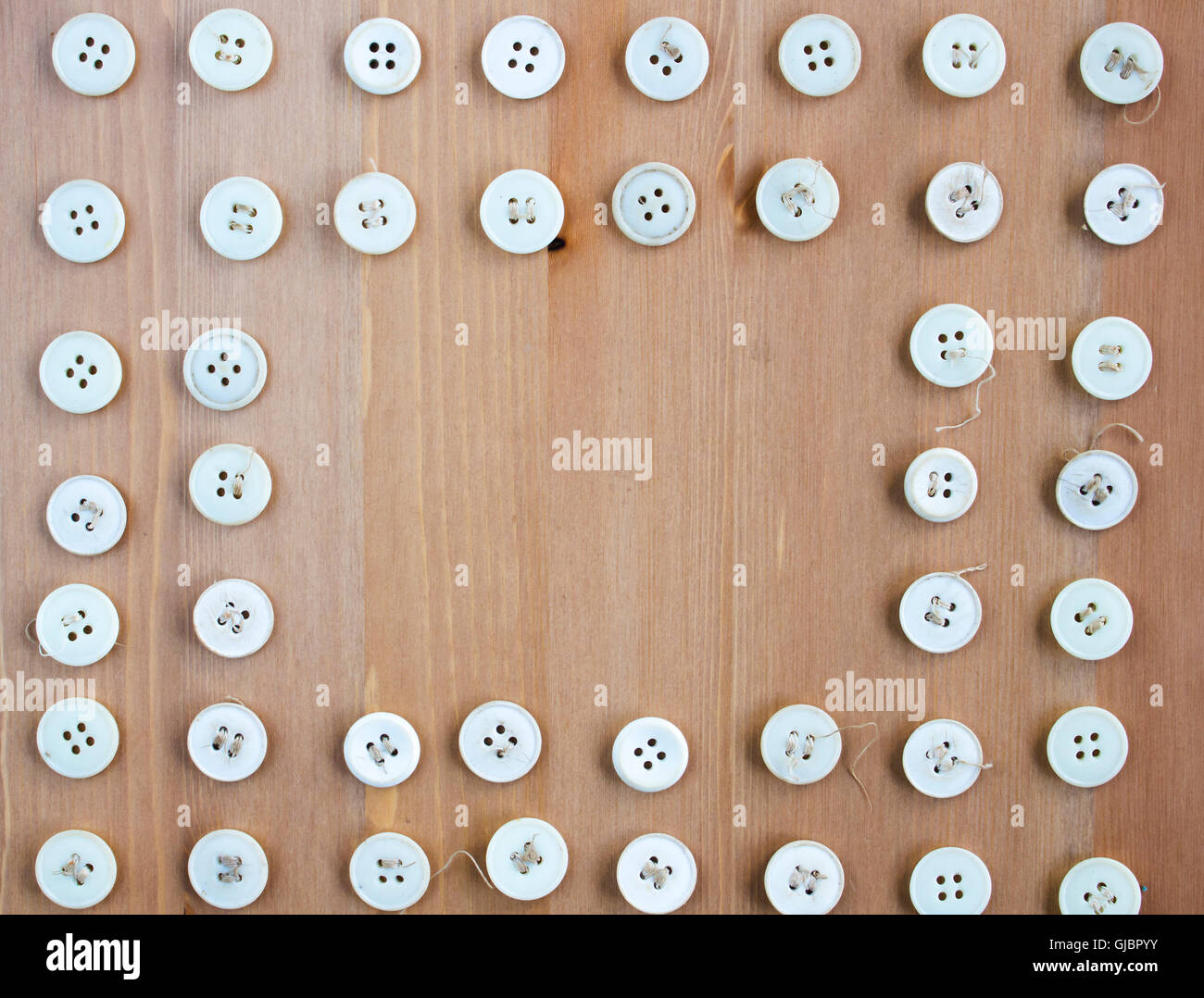 Old vintage buttons frame border on wooden background Stock Photo - Alamy