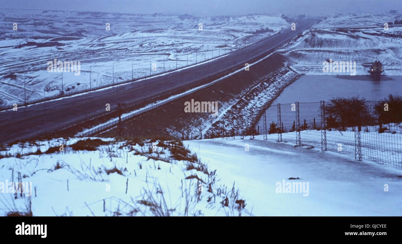 Grey sky snow view from the B6114 Saddleworth Road towards the M62 ...