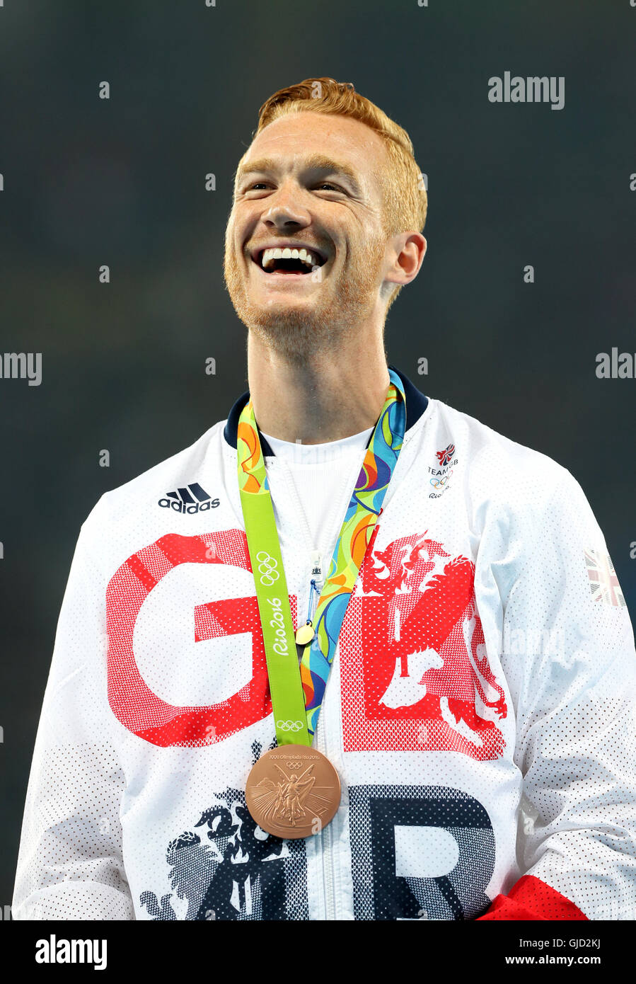 Great Britain's Greg Rutherford reacts on the podium with his bronze ...