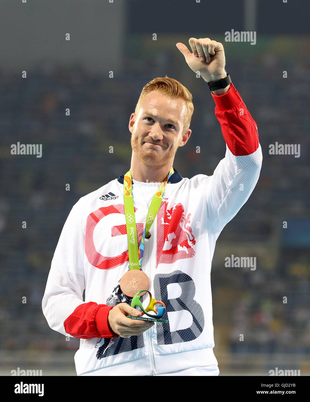 Great Britain's Greg Rutherford gestures to the crowd from the podium ...