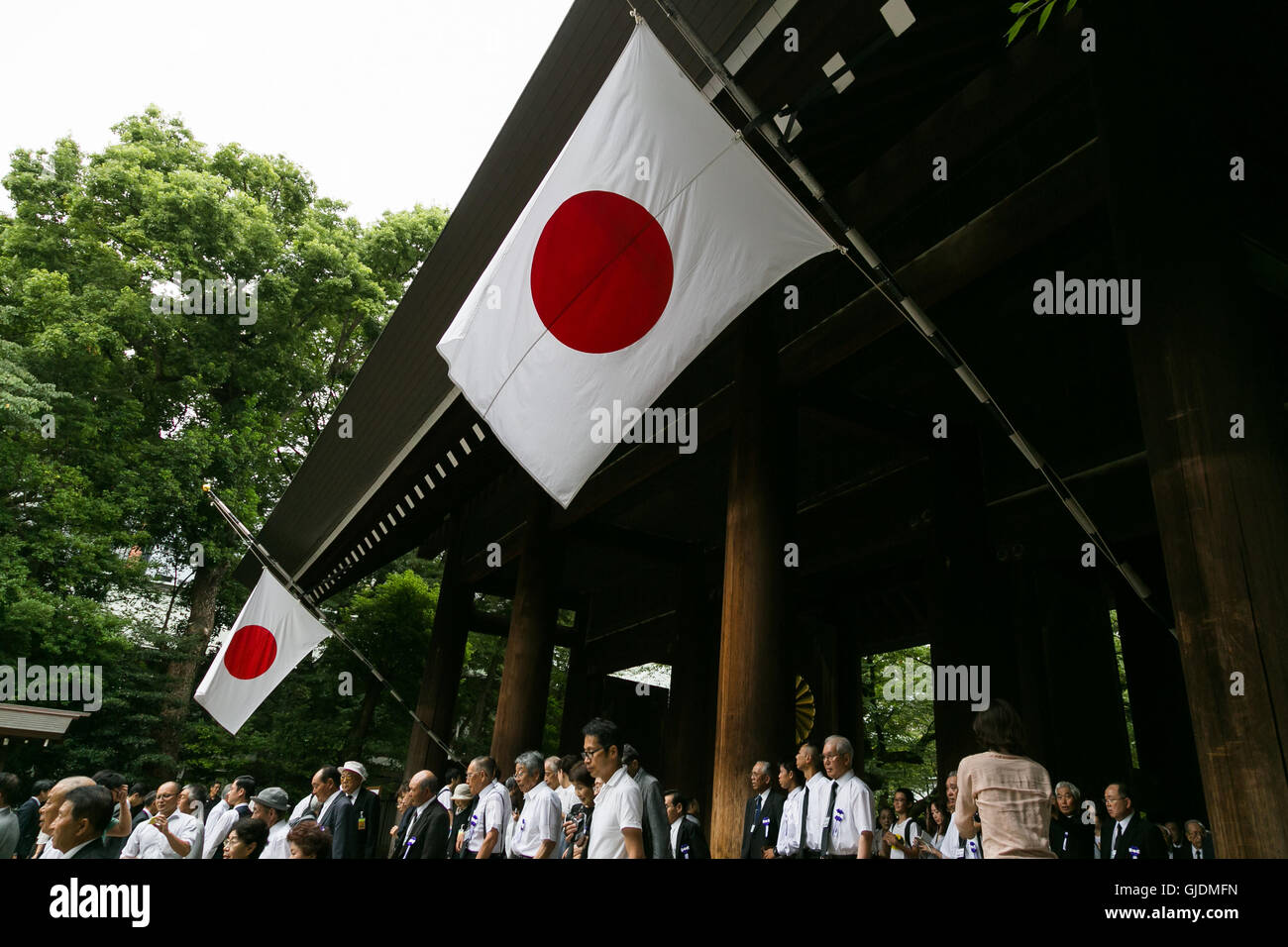 Tokyo, Japan. 15th Aug, 2016. People walk under Japanese flags flying ...
