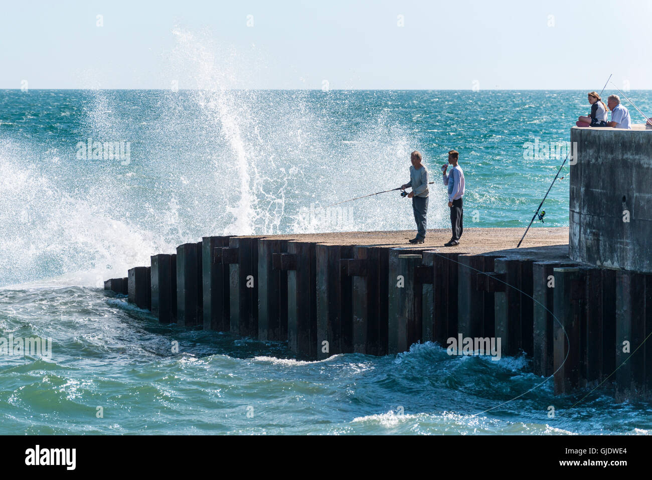 West Bay, Dorset, UK. 15th Aug, 2016. UK Weather. An angler braves a ...