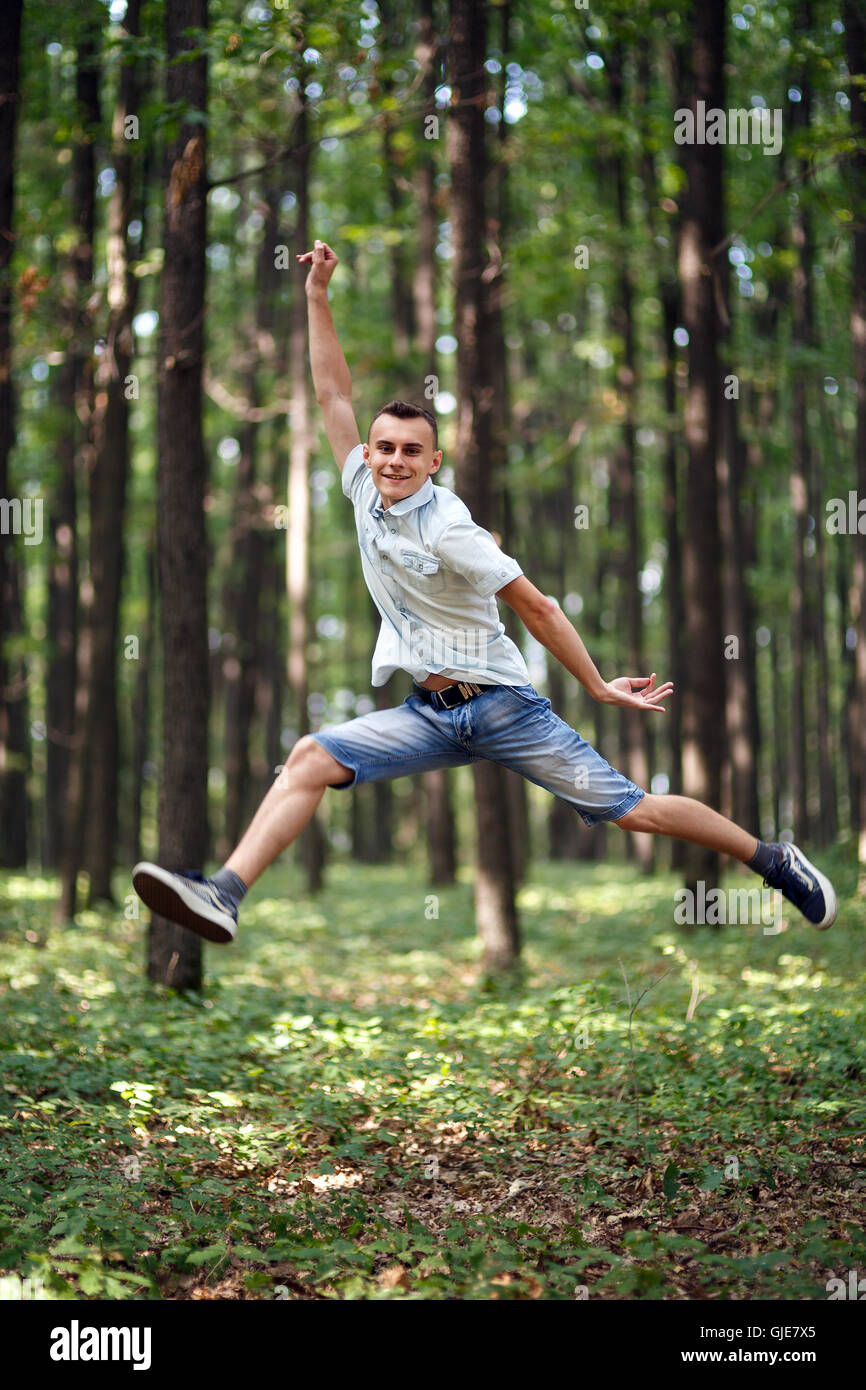 Young man jumping for joy outdoor in the park Stock Photo - Alamy