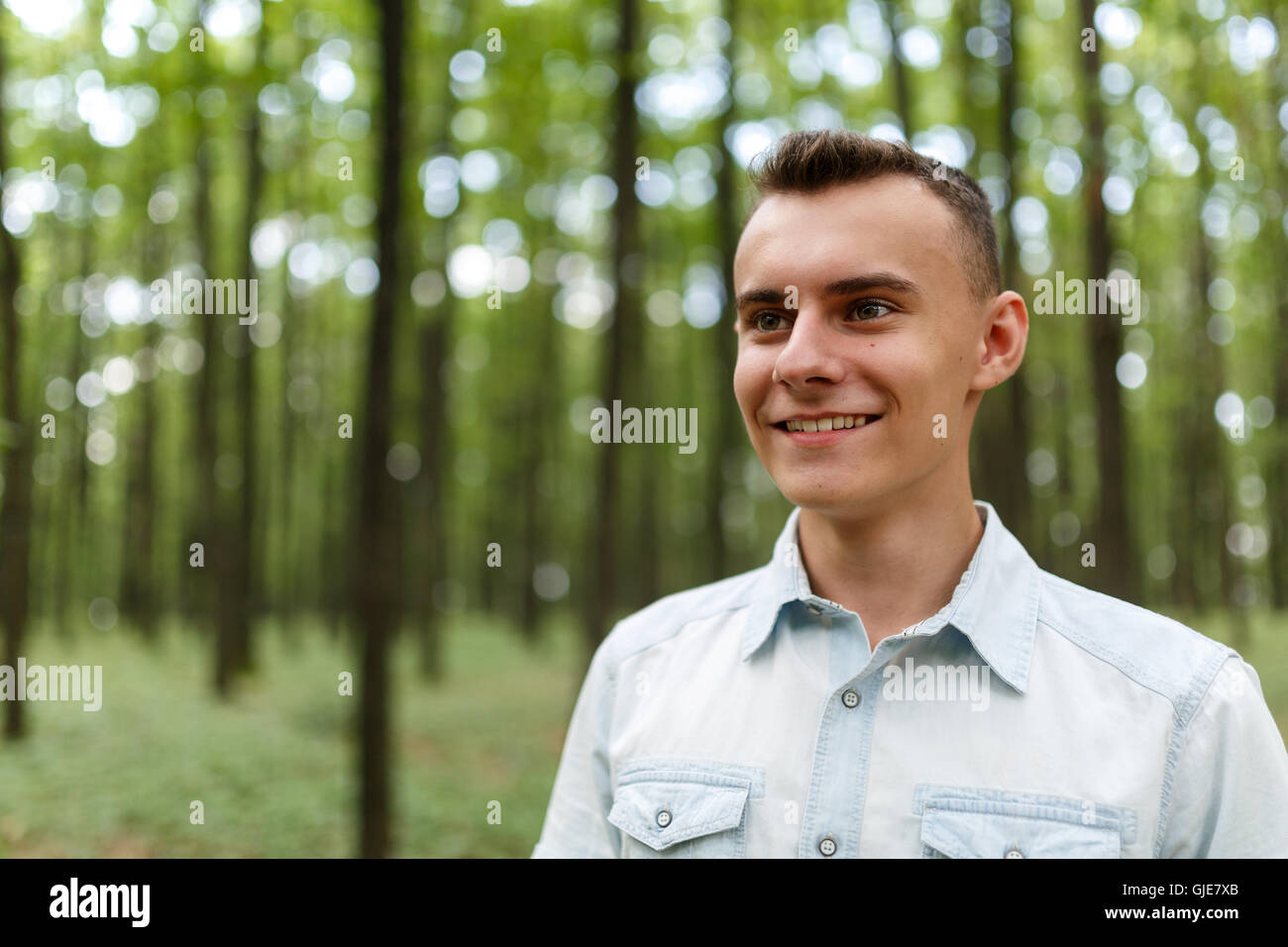 Happy young man in the park forest Stock Photo - Alamy
