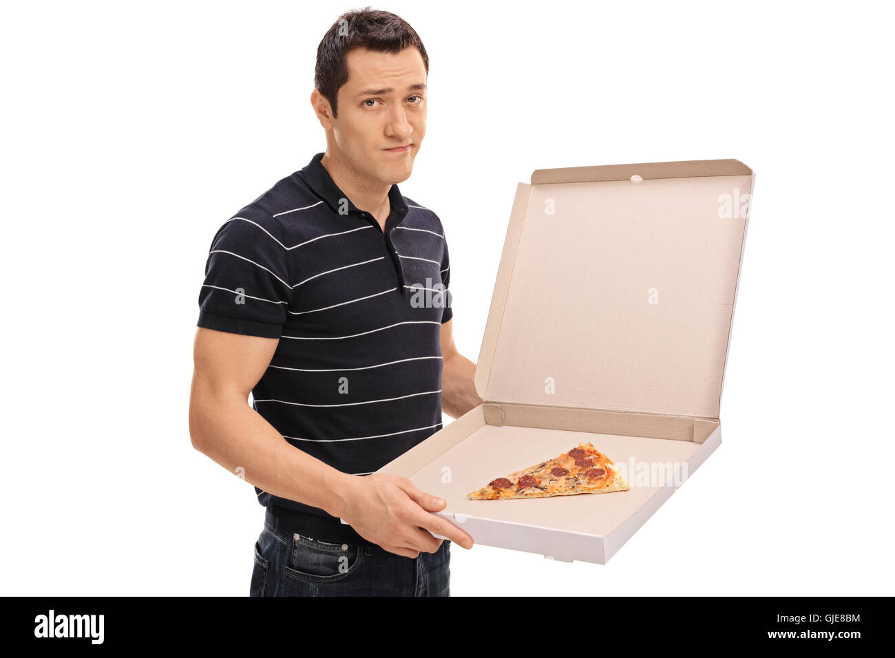 Disappointed young man holding a pizza box with one slice of pizza in ...