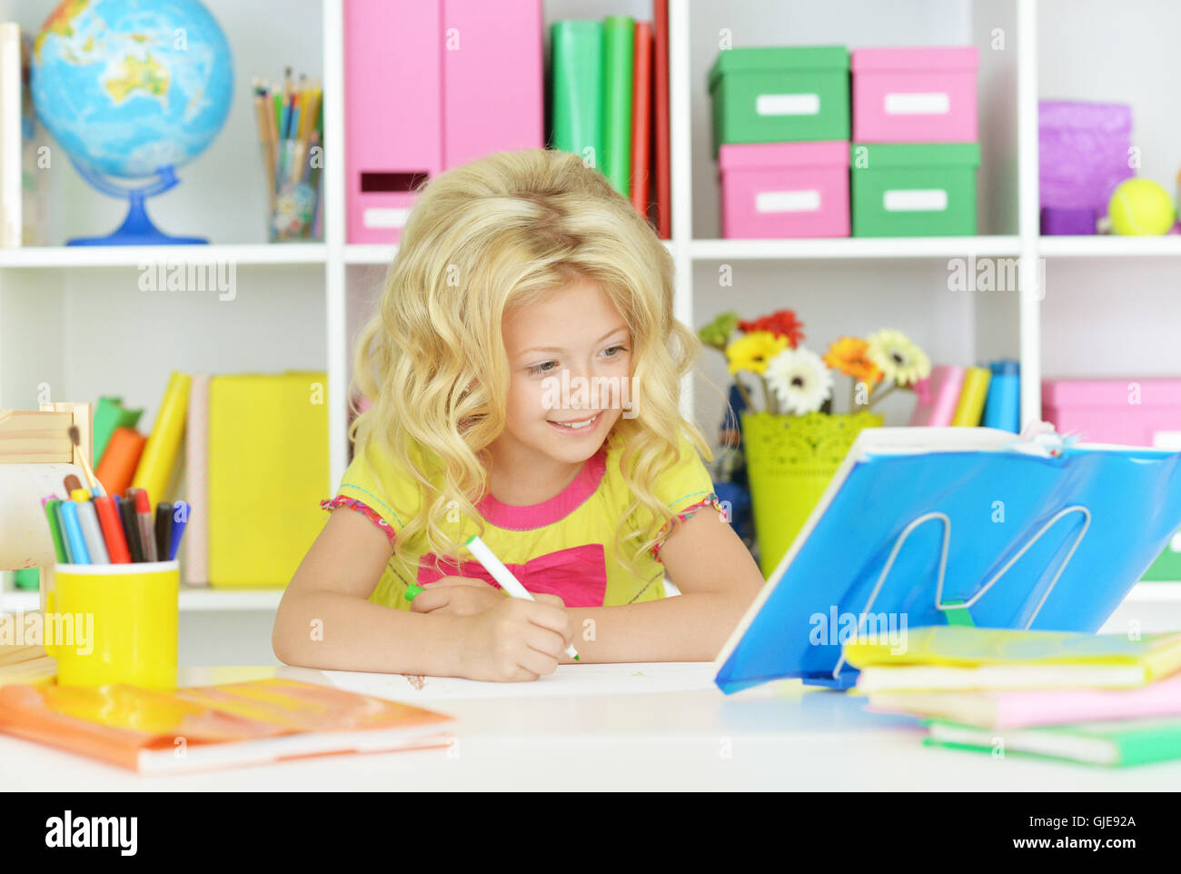 Little girl drawing at class Stock Photo - Alamy