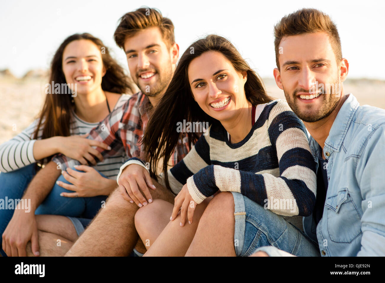 Multicultural group of friends at the beach having fun Stock Photo - Alamy
