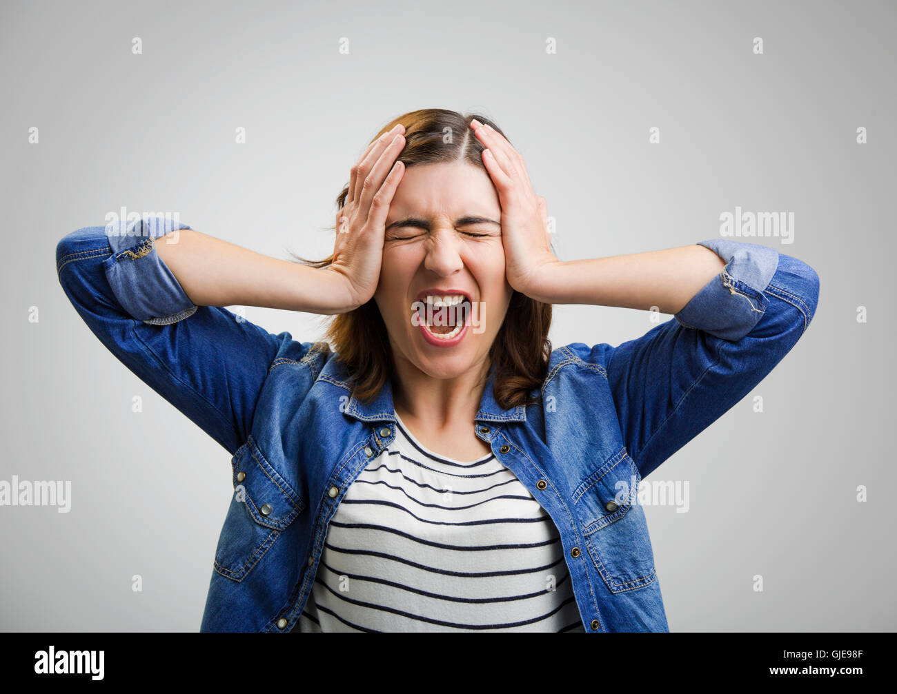 Portrait of a stressed woman holding head in hands Stock Photo - Alamy
