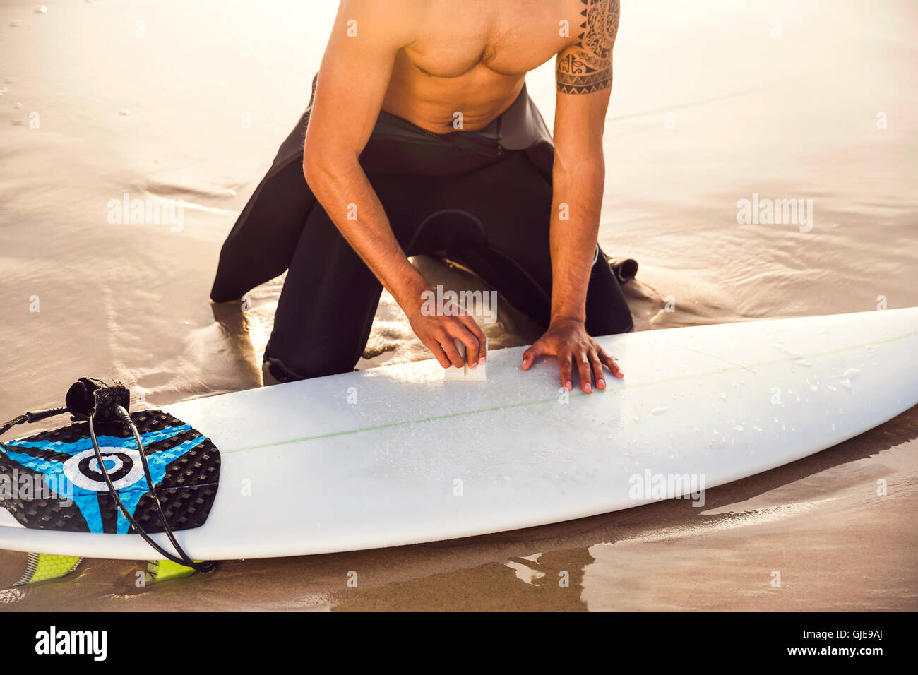 A surfer getting ready for the surf Stock Photo - Alamy