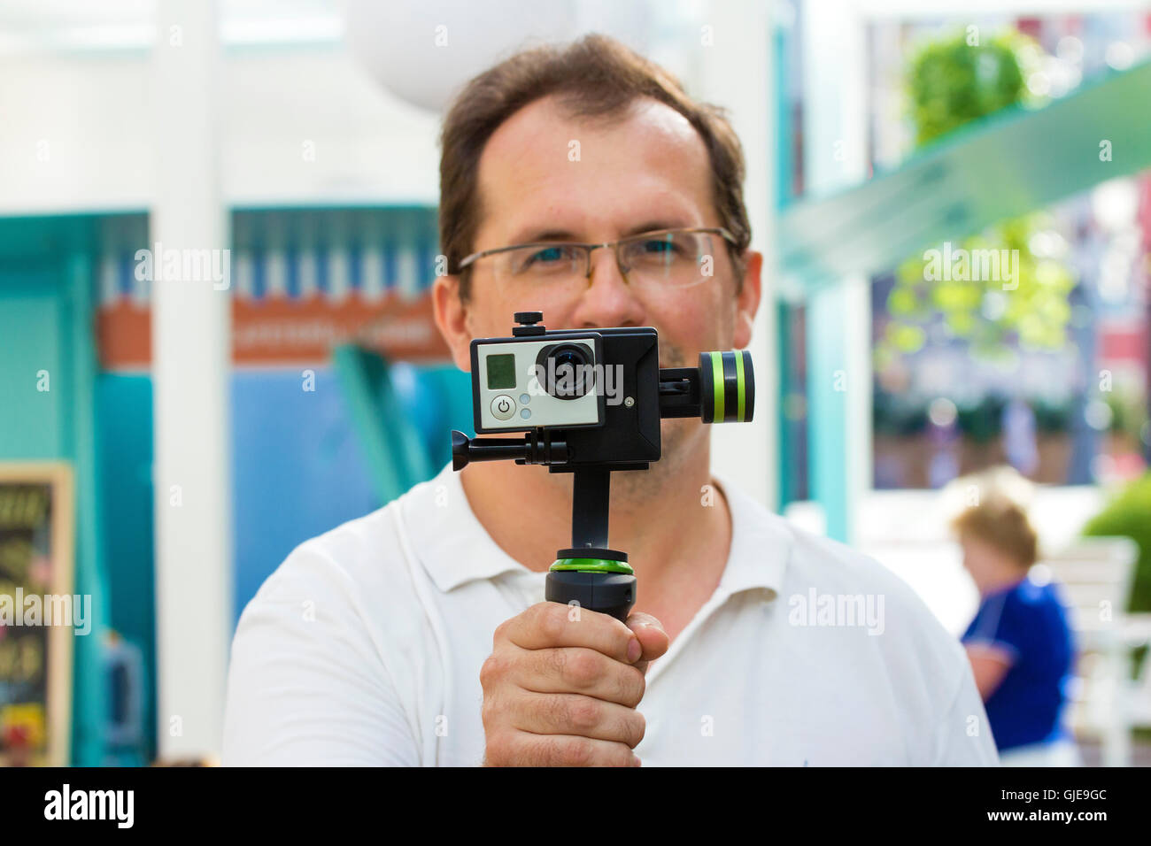 Man holds small action camera Stock Photo - Alamy