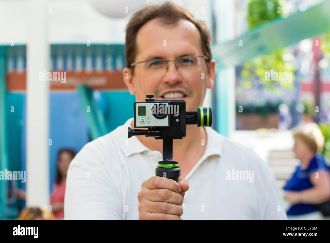 Man holds small action camera Stock Photo - Alamy