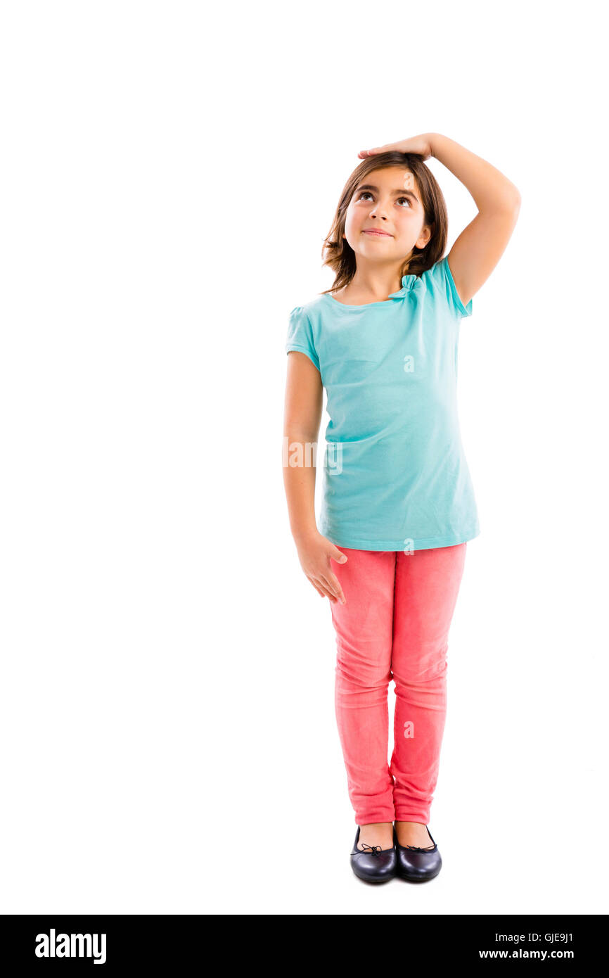 Little girl looking up and checking her size Stock Photo - Alamy