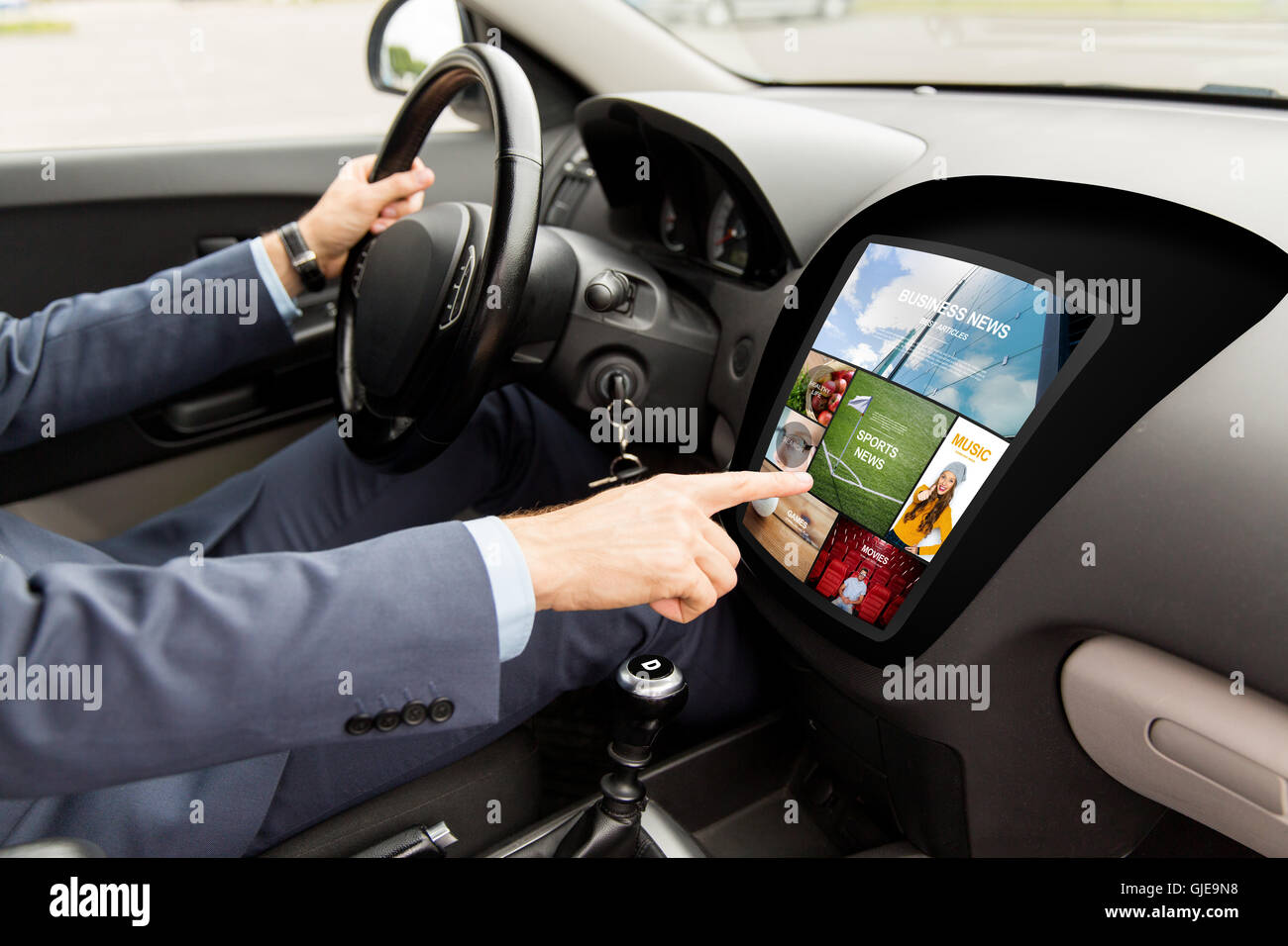 man driving car with news on board computer Stock Photo - Alamy