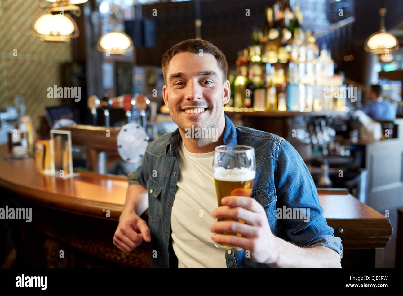 happy man drinking draft beer at bar or pub Stock Photo - Alamy
