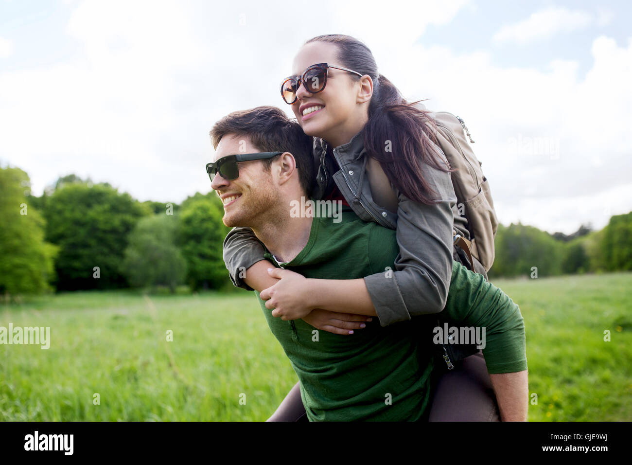 happy couple with backpacks having fun outdoors Stock Photo - Alamy