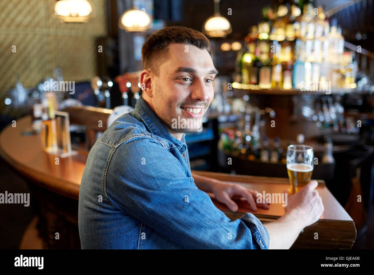 happy man drinking draft beer at bar or pub Stock Photo - Alamy